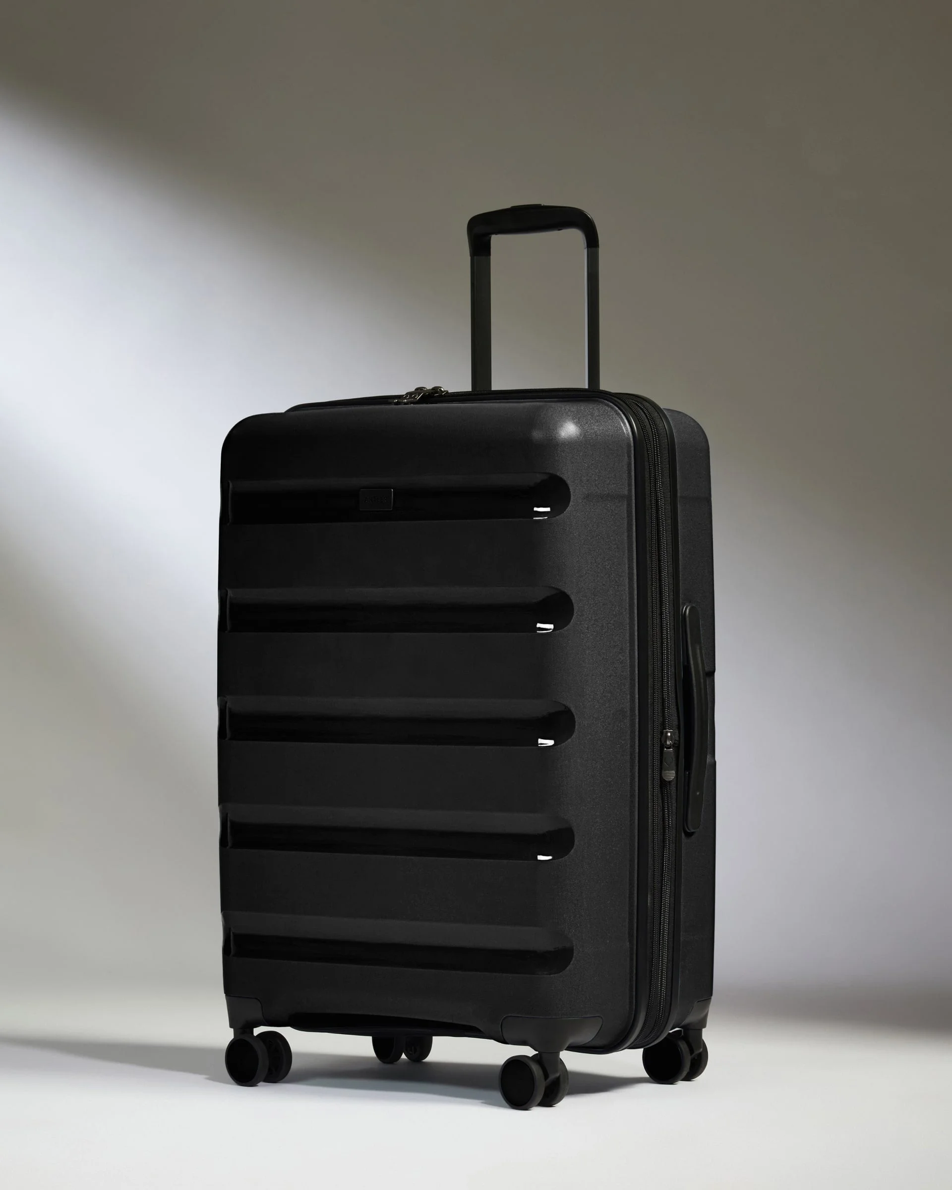 Medium Suitcase in Black - Logo Stripe - Borderfree